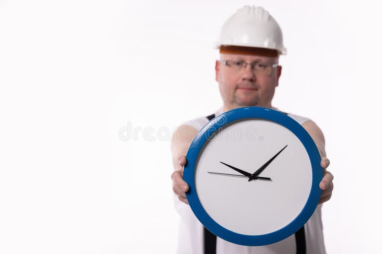 A Construction Worker Holds a Clock, Symbolizing Their Commitment To ...