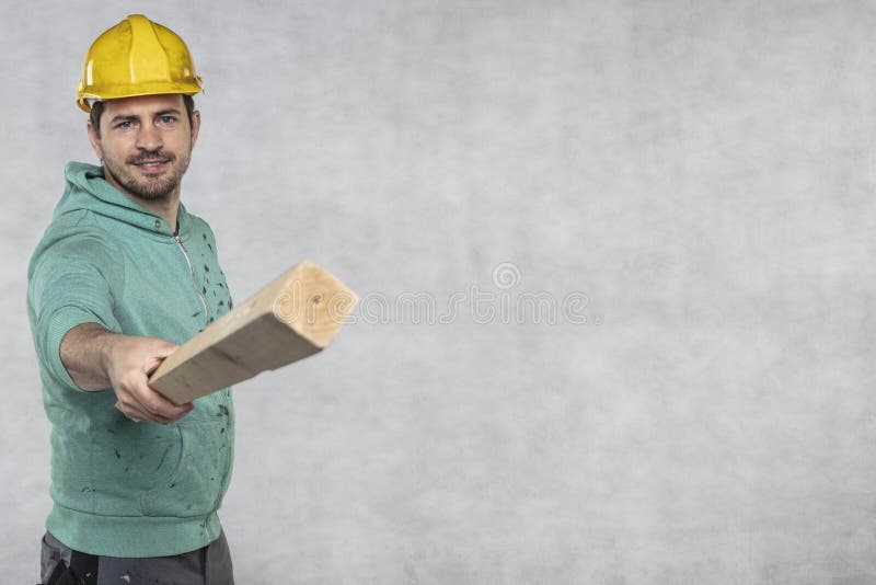 The Construction Worker Holds a Piece of Board in His Hands, the ...