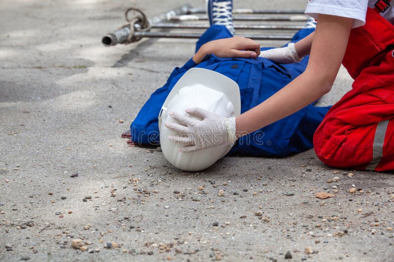 Worker Injured at Construction Site Receiving First Aid Assistance from ...