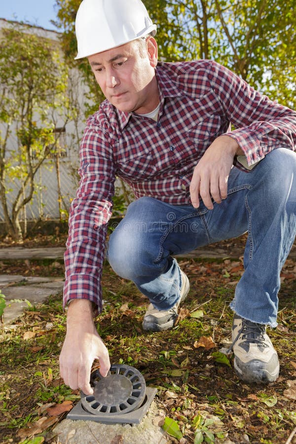 Construction Worker Inspecting Water Outlet in Garden Stock Photo ...