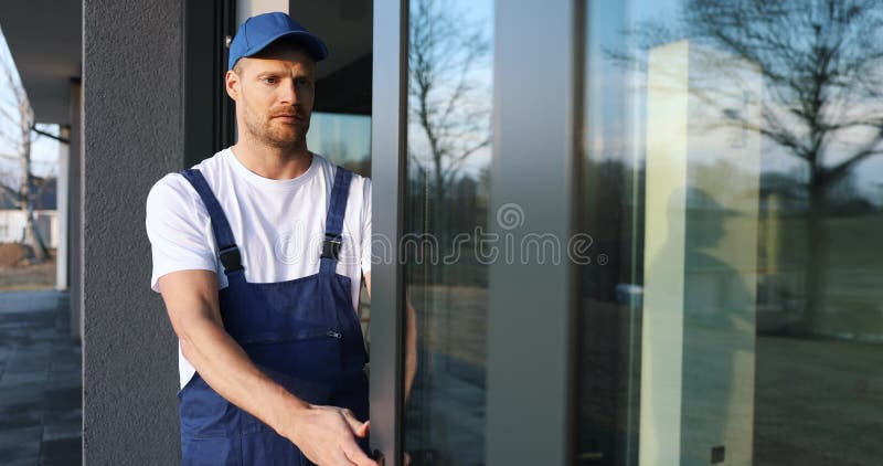 Worker Installing and Adjusting Aluminium Frame Sliding Terrace Doors ...