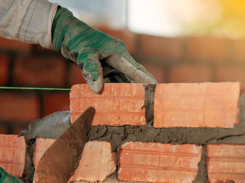 Construction Worker Installing Bricks in Construction Site Stock Photo ...