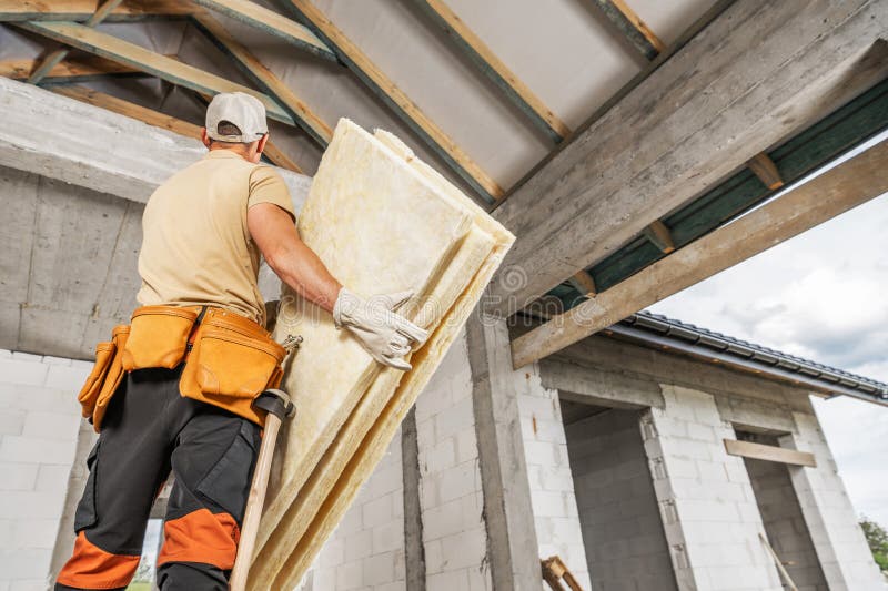 Construction Worker Installing Insulation in Residential Building Under ...