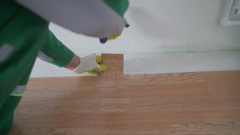 Construction Worker Installing Laminate Flooring Using Hammer Stock ...