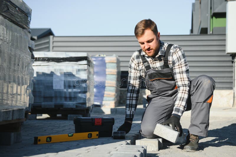 Construction Worker Installing and Laying Pavement Stones on Terrace ...