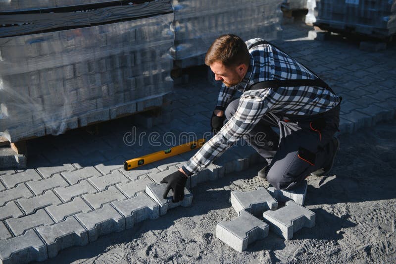 Construction Worker Installing and Laying Pavement Stones on Terrace ...