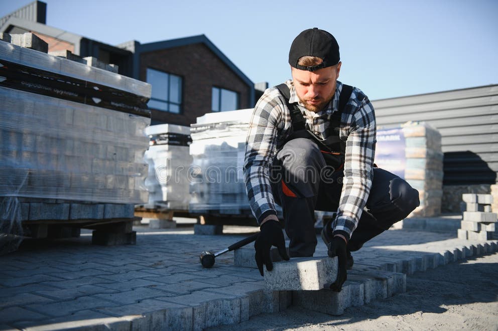 Construction Worker Installing and Laying Pavement Stones on Terrace ...