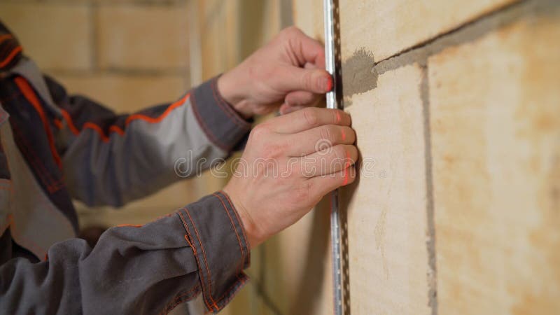 Construction Worker Installing Metal Corner Bead on Drywall with Laser ...