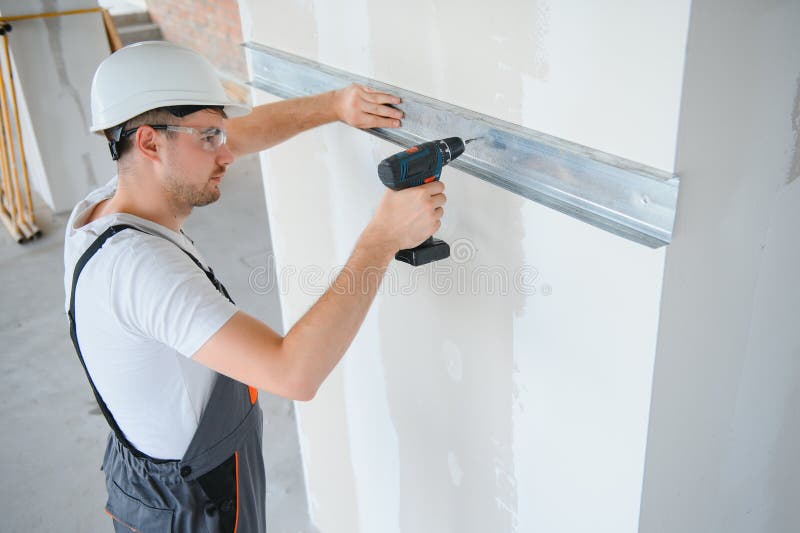 Construction Worker Installing Metal Profile for Interior Partition ...