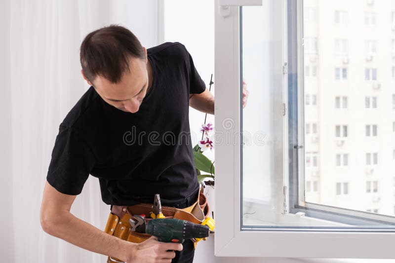 Construction Worker Installing Window in House. Handyman Fixing the ...