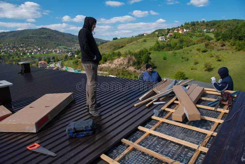 Construction Worker Installing a New Roof Stock Photo - Image of build ...