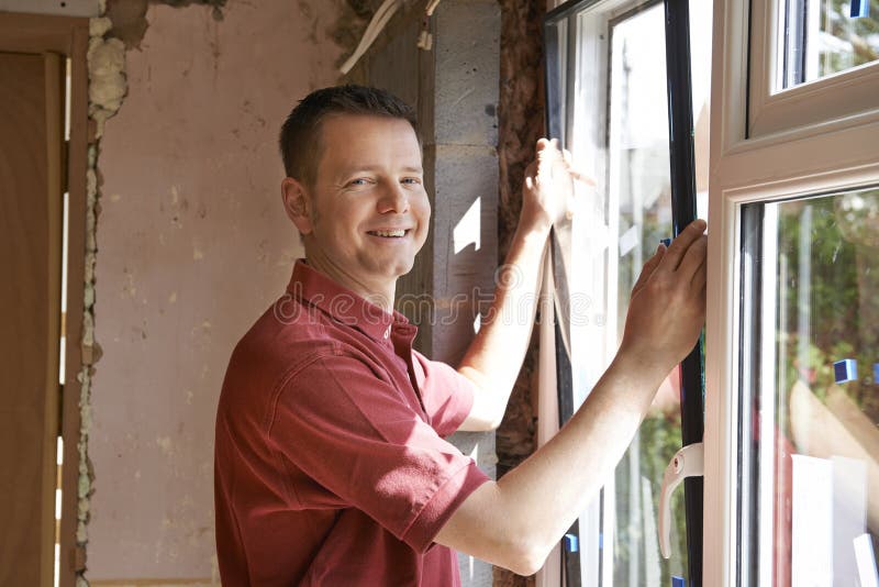 Construction Worker Installing New Windows in House Stock Photo - Image ...
