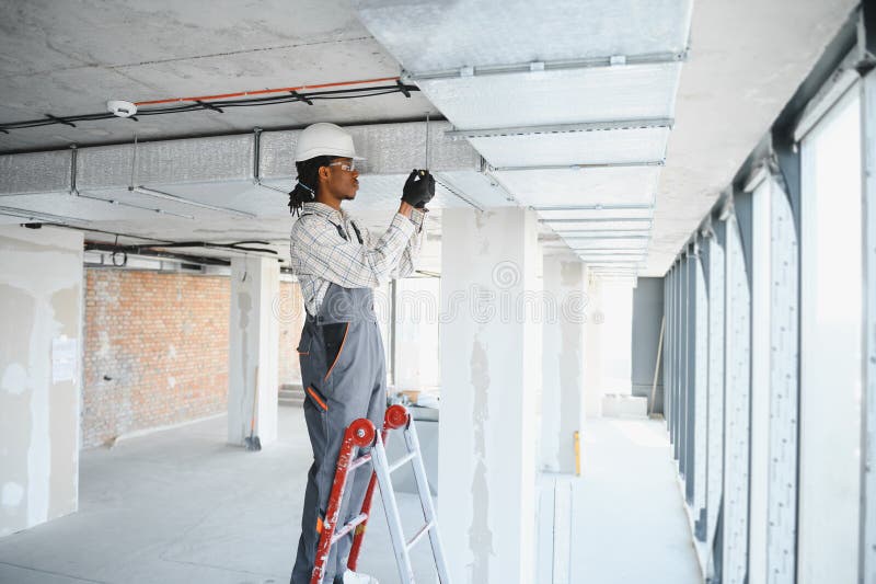 Construction Worker Installing Ventilation System on a Ladder Stock Photo - Image of helmet ...
