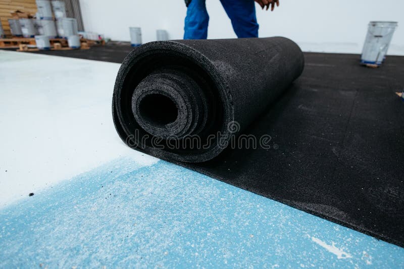 Construction Worker Installing Roofing Felt on Roof with Bitumen Rolls ...