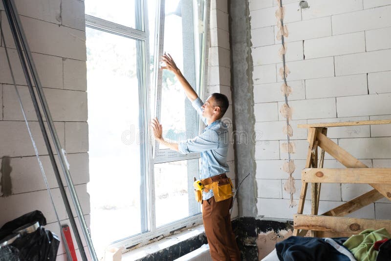 Construction Worker Installing Window in House Stock Image - Image of ...
