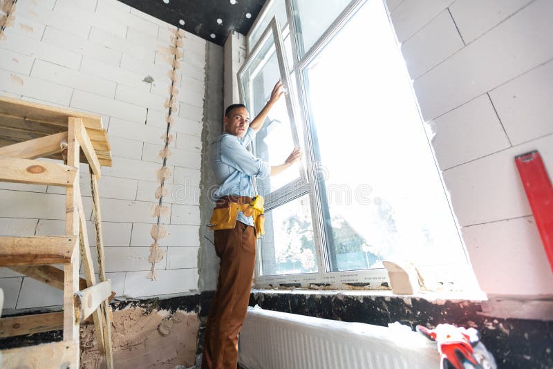 Construction Worker Installing Window in House Stock Photo - Image of ...