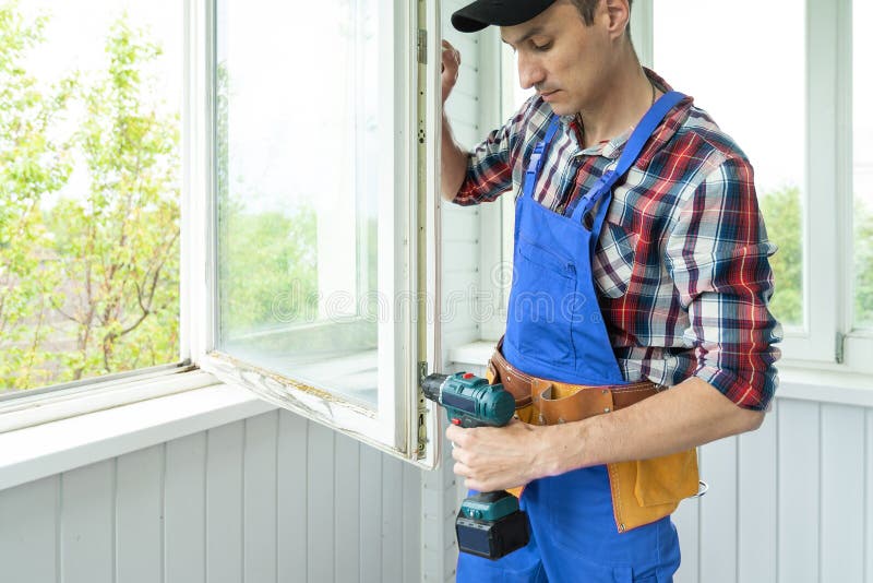 Construction Worker Installing Window in House. Handyman Fixing the ...