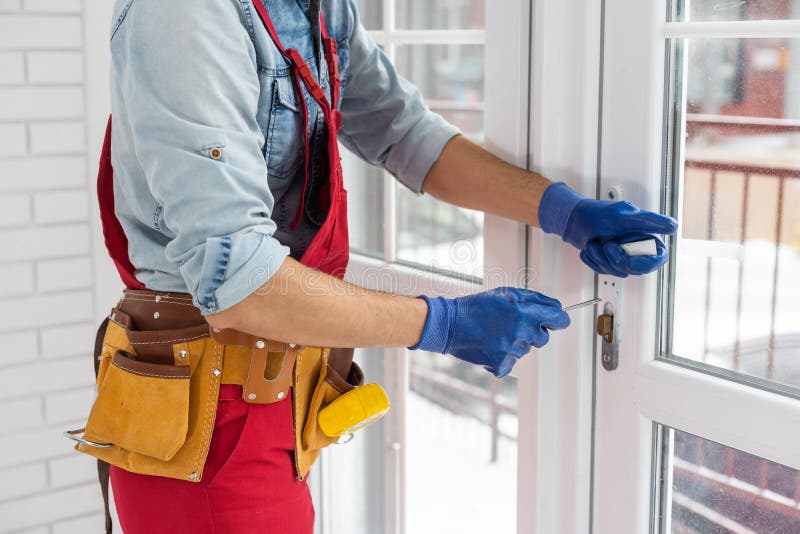 Construction Worker Installing Window in House. Handyman Fixing the ...