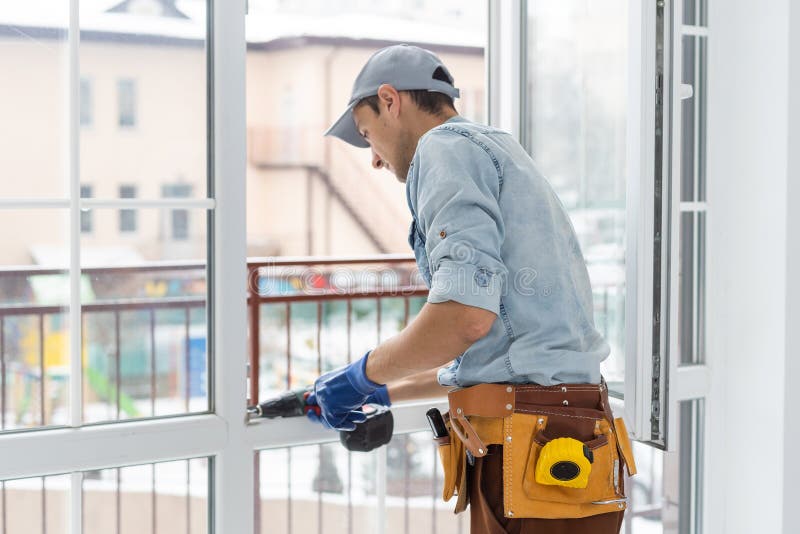 Construction Worker Installing Window in House. Handyman Fixing the ...