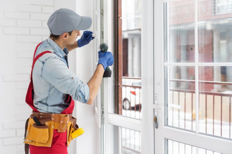 Construction Worker Installing Window in House. Handyman Fixing the ...