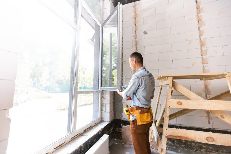 Construction Worker Installing Window in House Stock Image - Image of ...