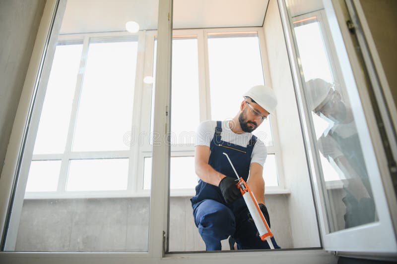 Construction Worker Installing Window in House Stock Photo - Image of ...