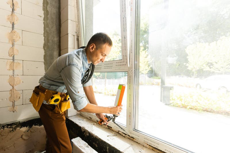 Construction Worker Installing Window in House Stock Photo - Image of ...