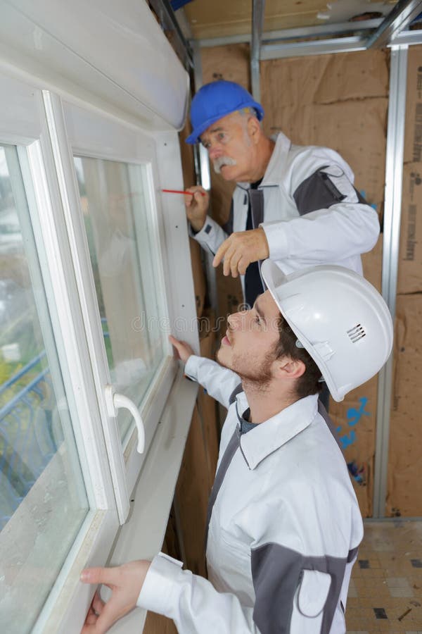 Construction Worker Installing Window in House Stock Photo - Image of ...