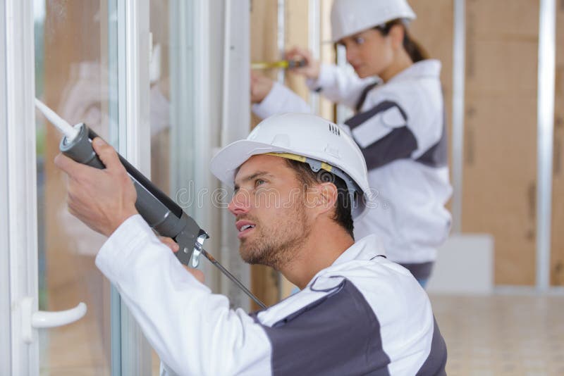 Construction Worker Installing Window in House Stock Image - Image of ...
