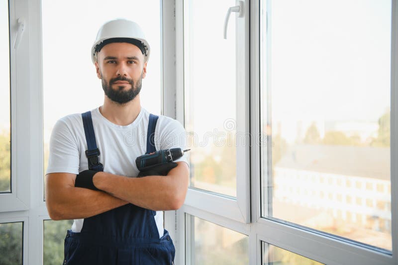 Construction Worker Installing Window in House. Handyman Fixing the ...