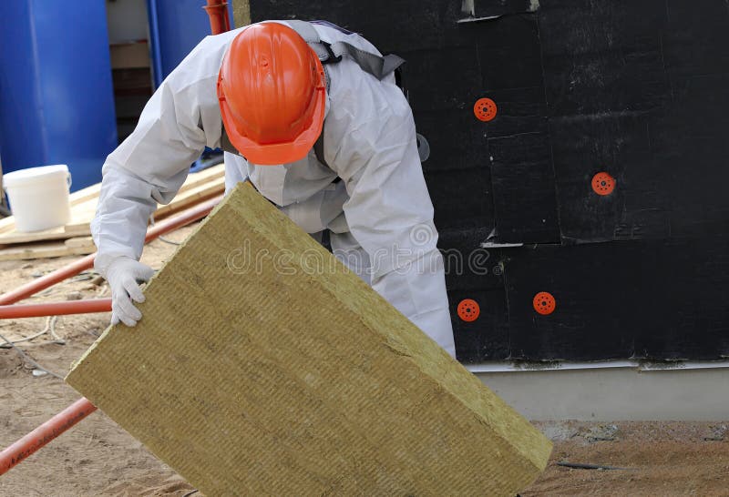 Construction Worker Installs Insulation Material at a Building Site ...