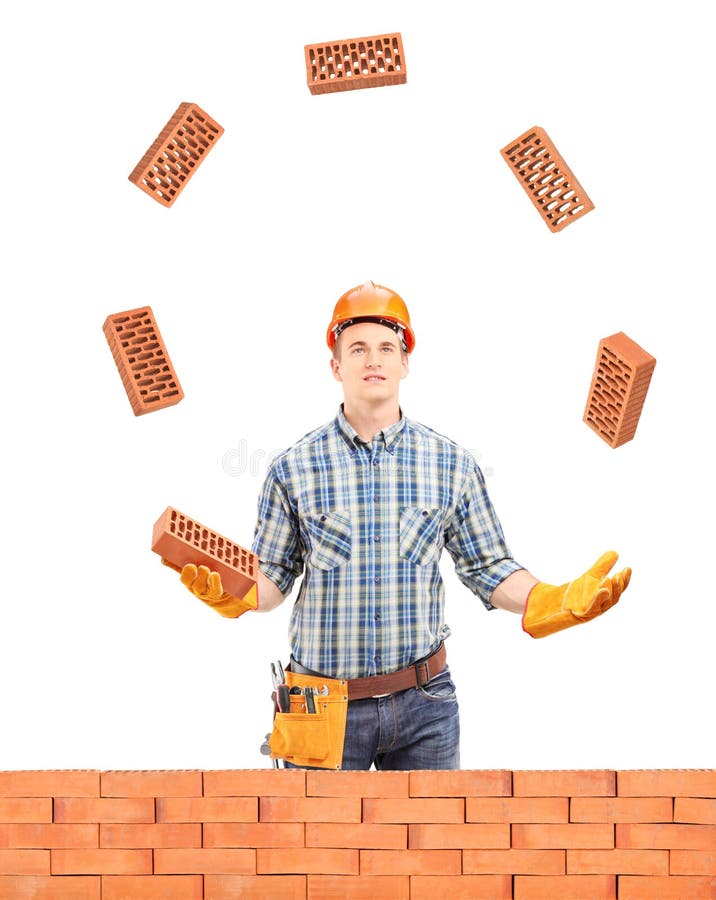 Construction Worker Juggling With Bricks Behind A Brick Wall Stock ...