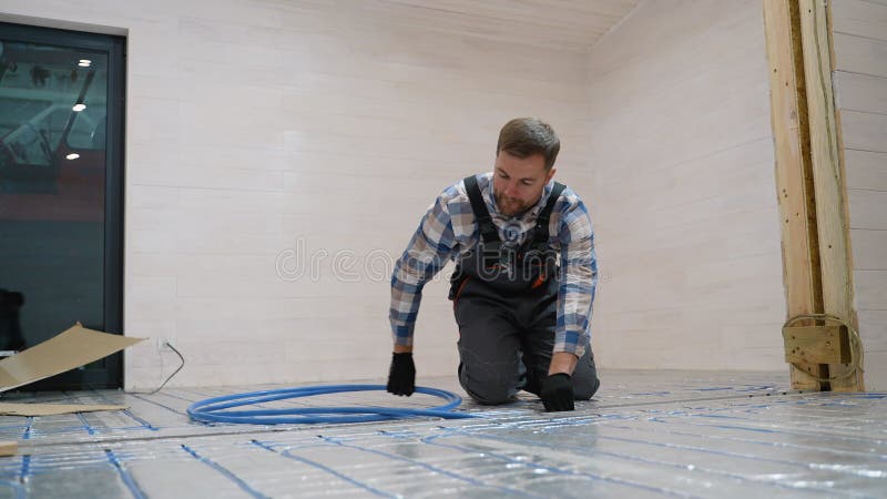 Worker Installing Underfloor Heating in Modular Home Stock Video ...