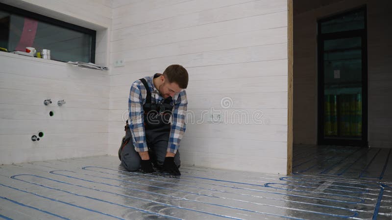 Technician Laying Underfloor Heating in Modular Home Stock Video ...