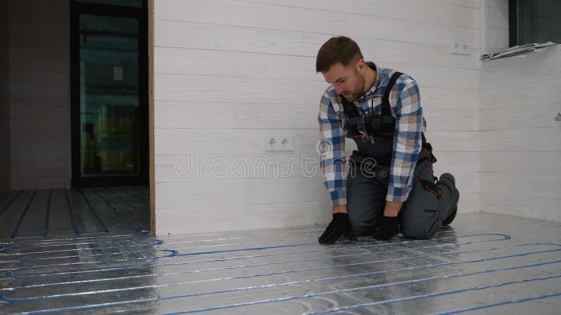 Worker Installing Underfloor Heating in Modular Home Stock Footage ...