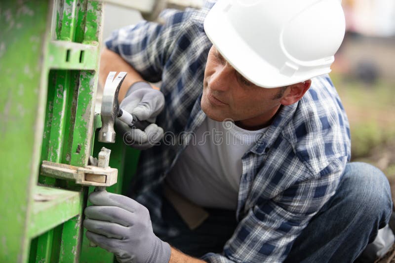 Construction Worker Knocking Pin through Hole with Hammer Stock Image ...