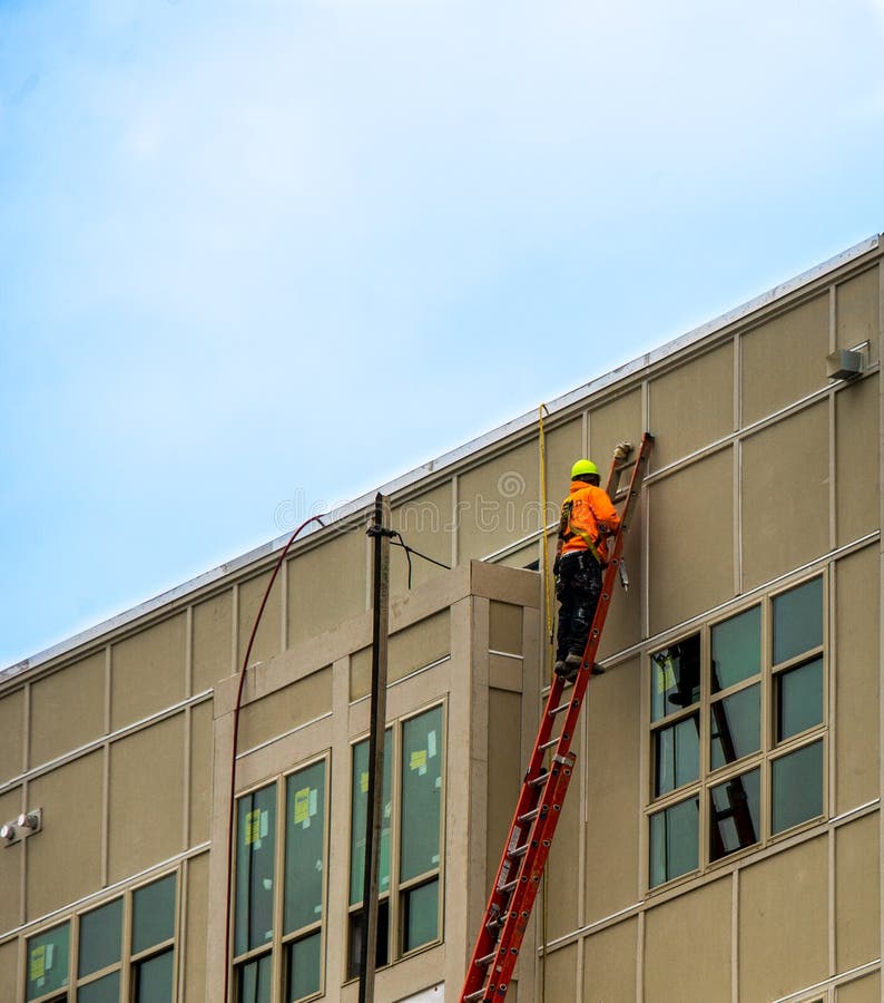 Construction Worker on Ladder on Exterior of Building Stock Photo ...