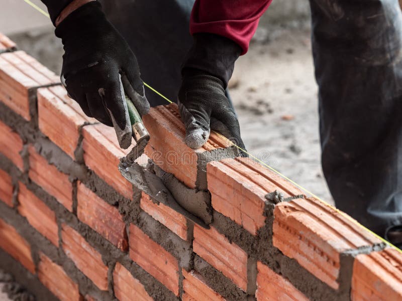 A Construction Worker Laying Bricks Showing Trowel and Guideline Stock ...