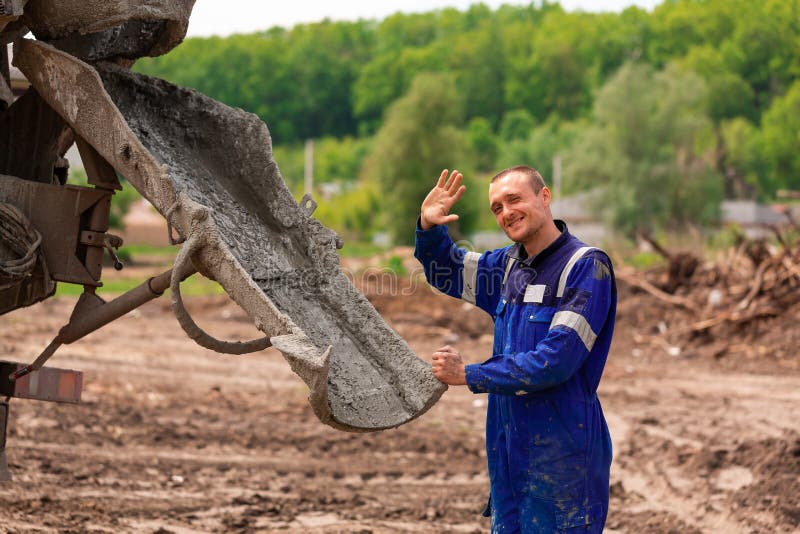 Construction Worker Laying Cement or Concrete into the Foundation ...