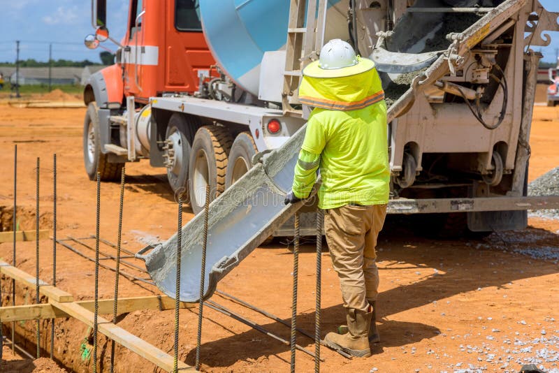 Construction Worker Laying Cement Concrete in Trenches for Building a ...