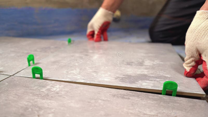 Laying of Ceramic Tiles at the Construction Site Stock Video - Video of ...