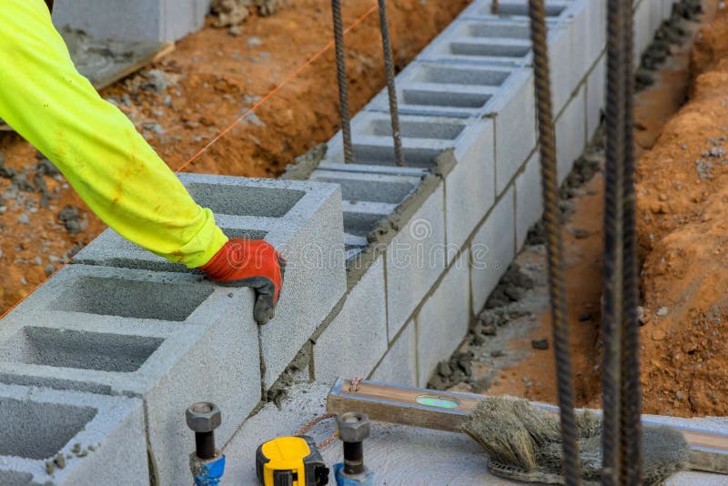 Construction Worker Lays Concrete Blocks at Building Site in Broad ...