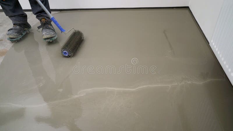 Construction Worker Leveling Concrete Surface Spiked Roller Stock ...