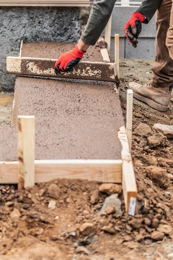 Construction Worker Leveling Wet Cement into Wood Framing Stock Image ...