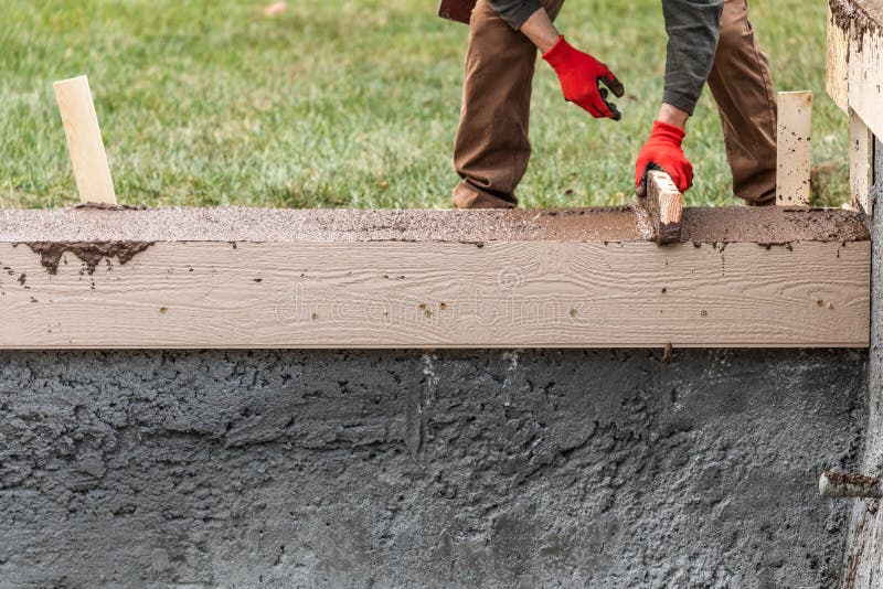 Construction Worker Leveling Wet Cement into Wood Framing Stock Image ...