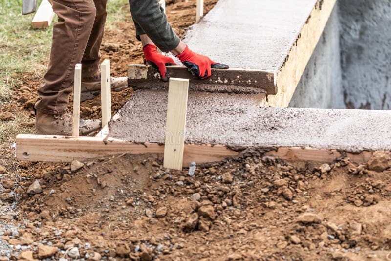 Construction Worker Leveling Wet Cement into Wood Framing Stock Photo ...