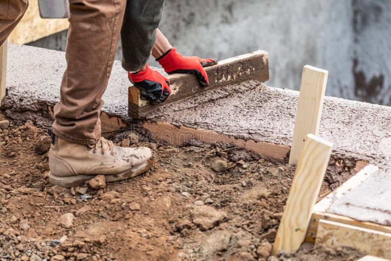Construction Worker Leveling Wet Cement into Wood Framing Stock Image ...