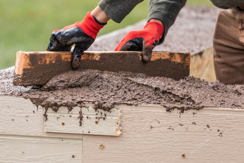 Construction Worker Leveling Wet Cement into Wood Framing Stock Image ...