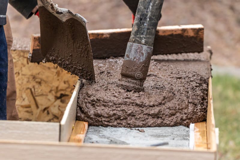 Construction Worker Leveling Wet Cement into Wood Framing Stock Image ...