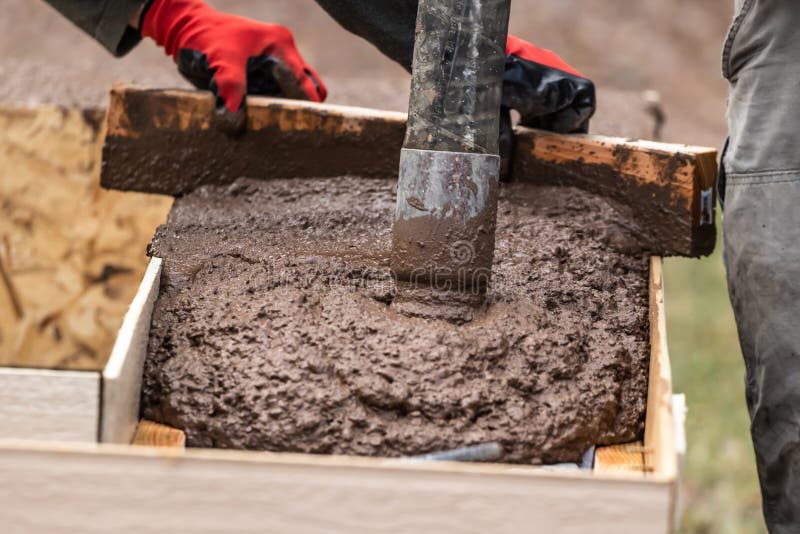 Construction Worker Leveling Wet Cement into Wood Framing Stock Photo ...